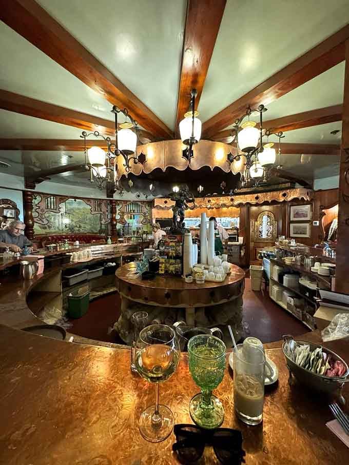 The bar area gleams with old-world charm, where even your morning coffee feels like a fancy cocktail hour.