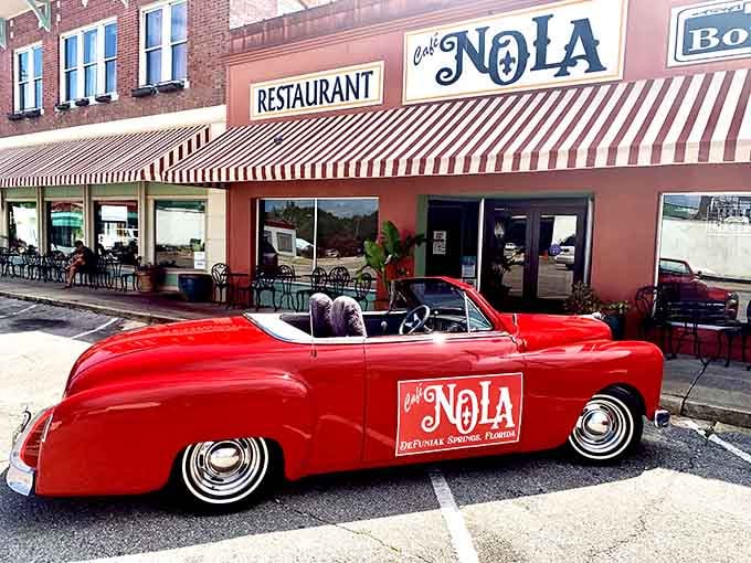 That classic red convertible parked outside Cafe Nola looks ready to cruise straight into a 1950s dream you didn't know you had.