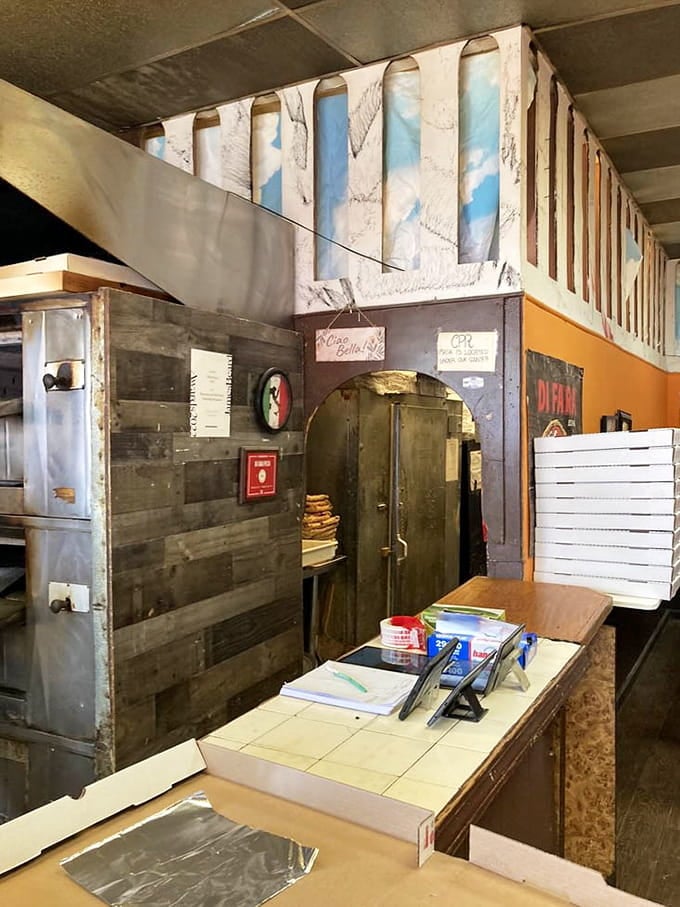 That vintage oven has seen more pizzas than most people have seen sunrises, and it shows no signs of retiring.