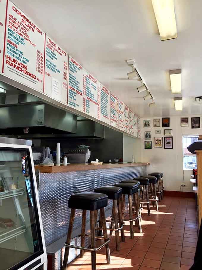 The long counter with its metal facade invites you to sit, stay awhile, and witness breakfast burrito artistry firsthand.
