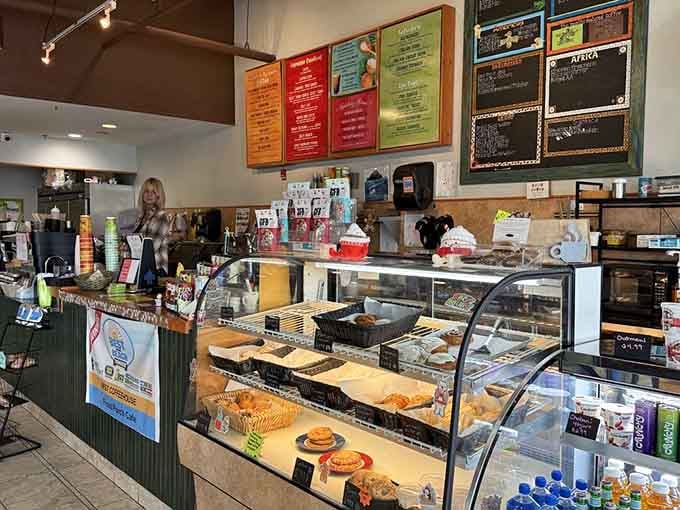The counter displays pastries and coffee options like edible treasures waiting to be discovered by you.
