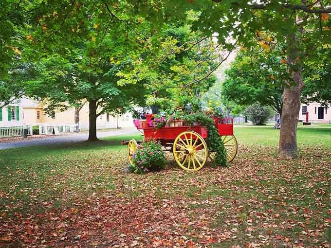 A decorative wagon adds charm to the village green, proving that yard art has always been a thing.