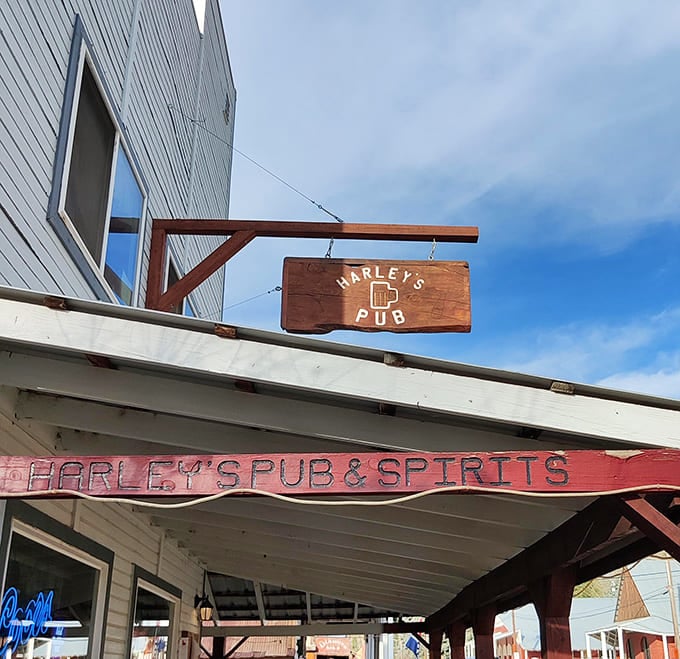 Harley's Pub sign swings with the promise of cold brews and warm conversation&mdash;some things never change in mountain towns.