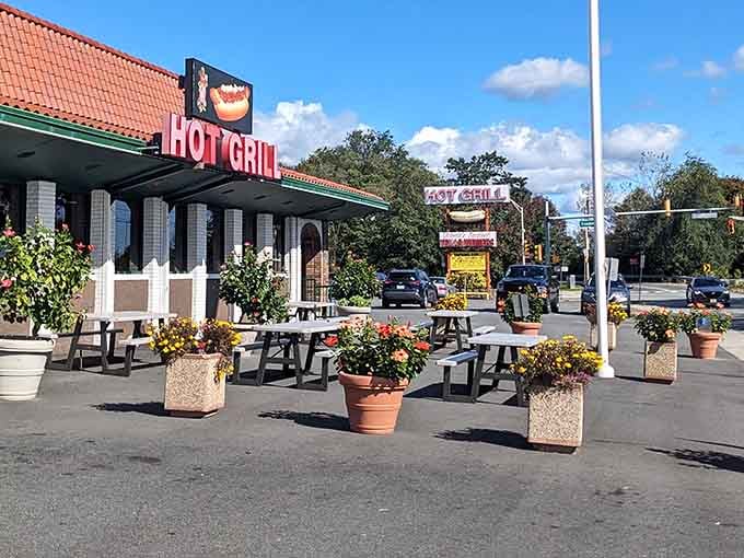 Outdoor seating with planters full of flowers, because even roadside diners deserve a little garden party atmosphere.