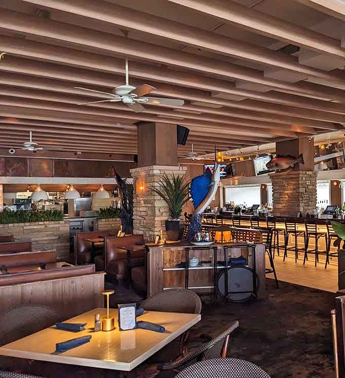 The dining room's warm wood tones and nautical touches create ambiance without overdoing the beach theme.