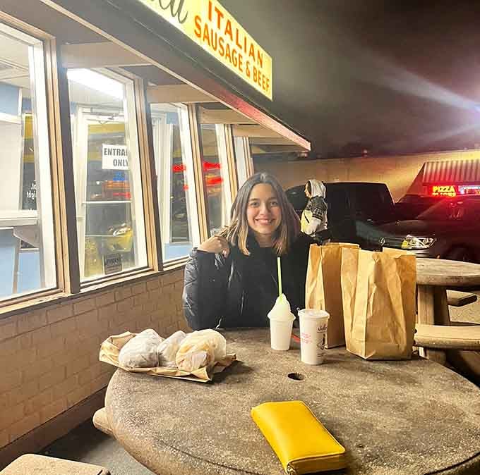 Pure joy captured at a picnic table, proving the best meals don't require fancy dining rooms or complicated reservations.