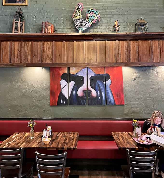 Cozy booth seating with quirky cow artwork makes every breakfast feel like a fun little escape from reality.