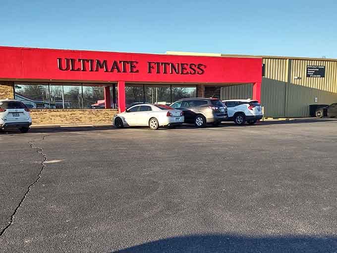 Red awnings beckon fitness enthusiasts who prefer hometown gyms over intimidating corporate wellness factories.