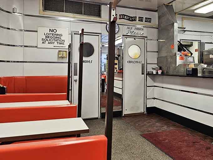 Red booths offering cozy corners for families to create new memories over burgers, fries, and those legendary malts.