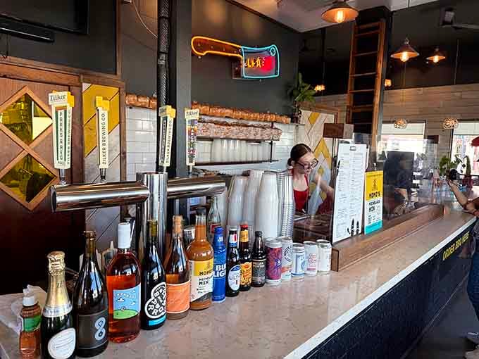 The counter area displays local beverages and merchandise, turning a simple ordering spot into a celebration of Austin culture.