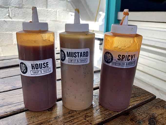 House-made sauces in squeeze bottles offer tangy, spicy, and mustard options for those who want them.