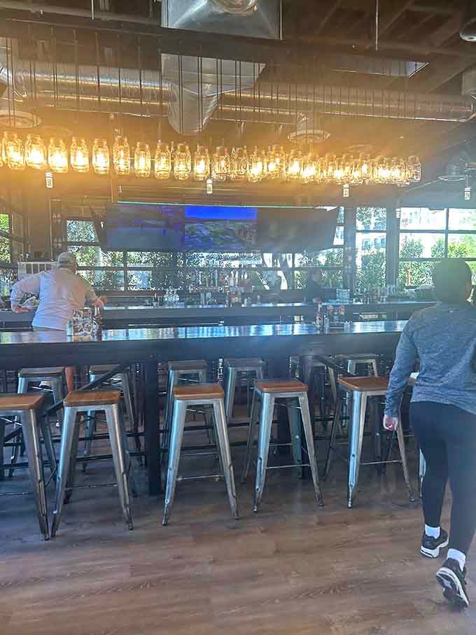 The bar area with its mason jar chandelier sets a casual vibe for pre-meal drinks or post-meal recovery.