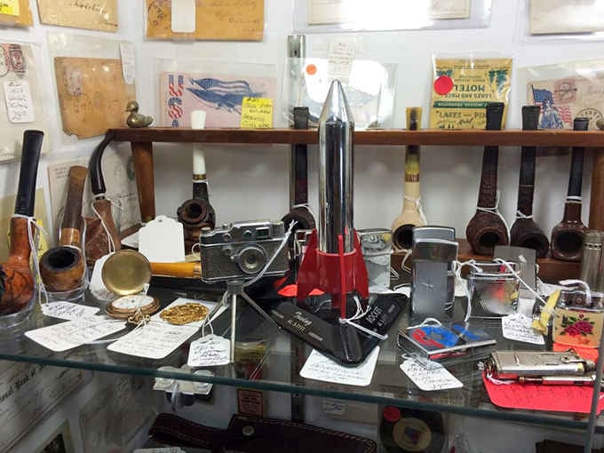 Vintage cameras and pipes arranged like a museum exhibit dedicated to when men wore hats daily and nobody needed Instagram filters.