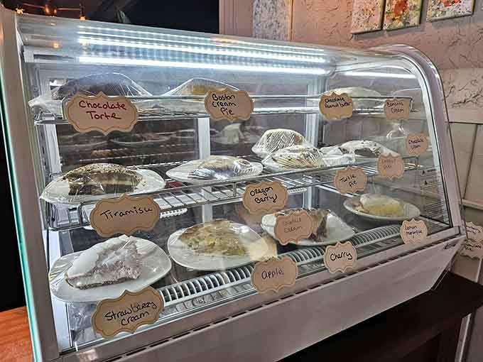 The pie case displaying homemade temptations behind glass, each slice calling your name with increasing urgency.