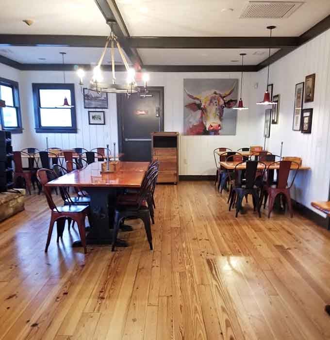 Colorful metal chairs and cow artwork add personality to a dining room that knows how to balance fun with functionality.