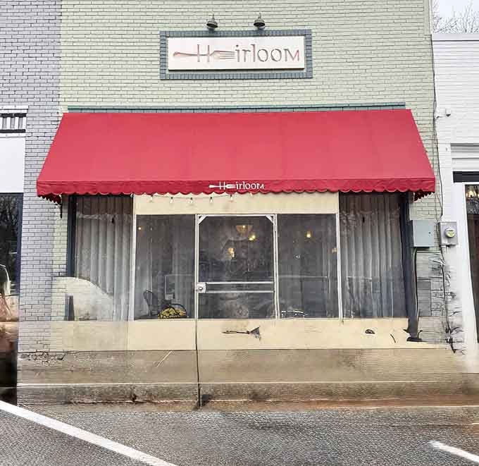 Heirloom Restaurant's red awning beckons like a dinner bell, promising the kind of meal that becomes a fond memory.