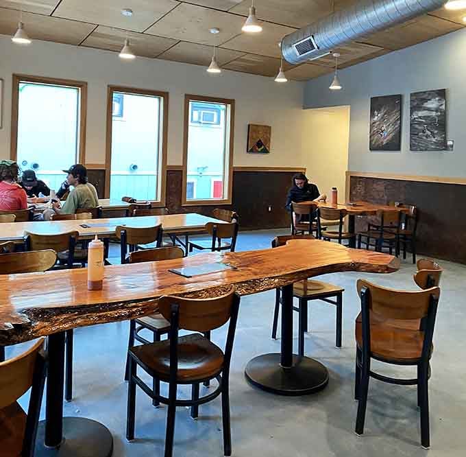 Live-edge wood tables add rustic charm while you plan tomorrow's adventure over today's pizza.