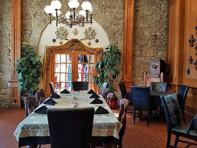 Exposed stone walls and elegant table settings prove that history and comfort make excellent dining companions here.