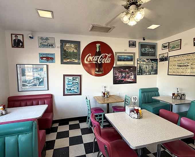Vintage Coca-Cola signs and framed car photos create a museum you can actually eat in without security guards yelling.