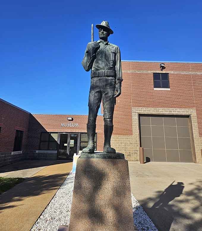 A solemn bronze sentinel stands watch outside the museum, honoring generations of Missouri service members with quiet dignity.