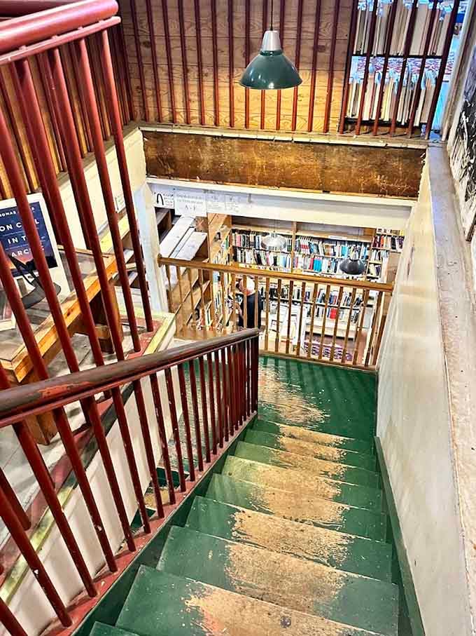 The worn staircase beckons you upward, promising even more literary treasures on the floors above ground level.