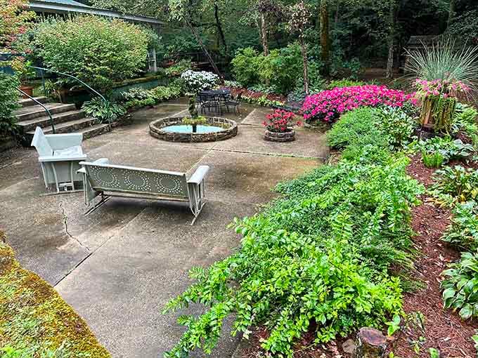 A peaceful garden area provides colorful beauty before you descend into the canyon's ancient, moss-covered realm below.