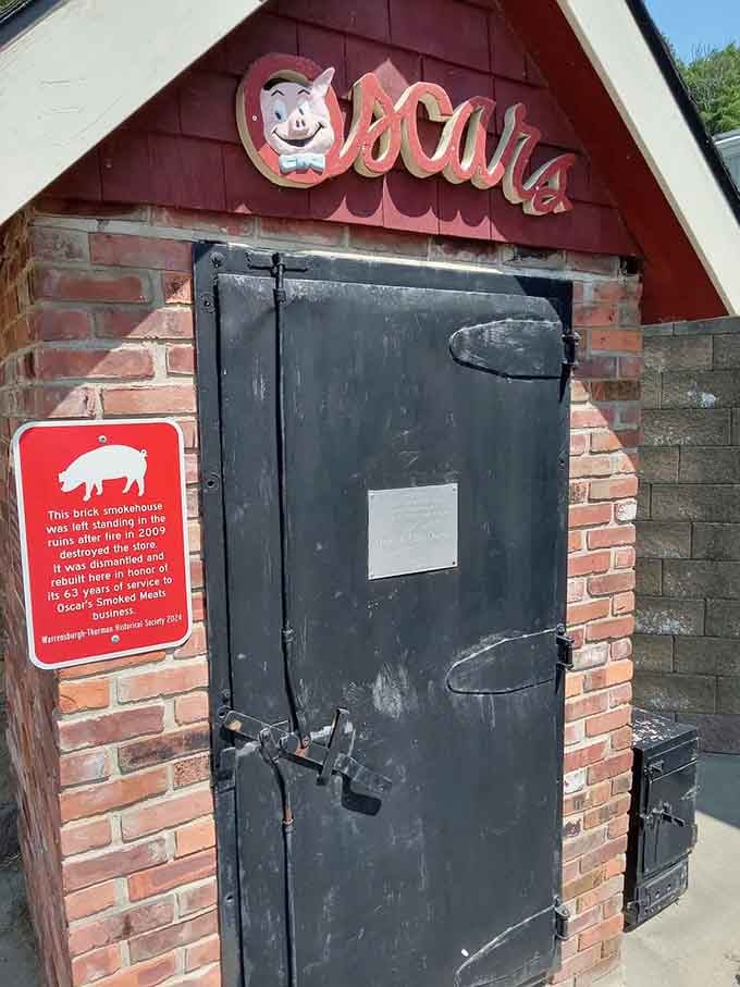 The original brick smokehouse standing proud—a monument to decades of doing one thing exceptionally well without shortcuts.