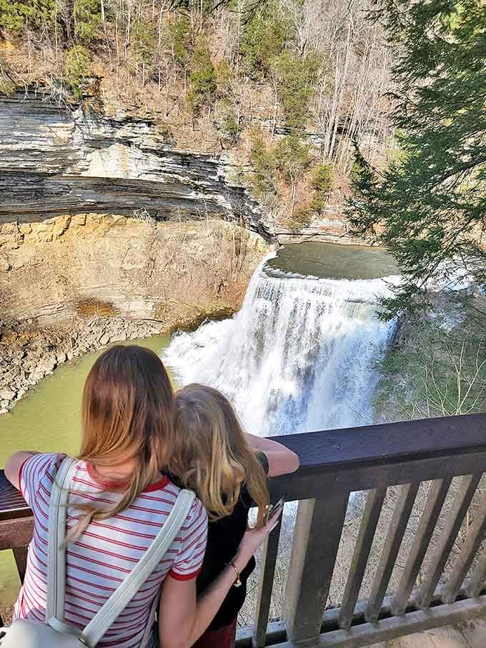Two visitors share a moment of waterfall wonder&mdash;proof that some views are best enjoyed with someone else's gasp of amazement joining your own.