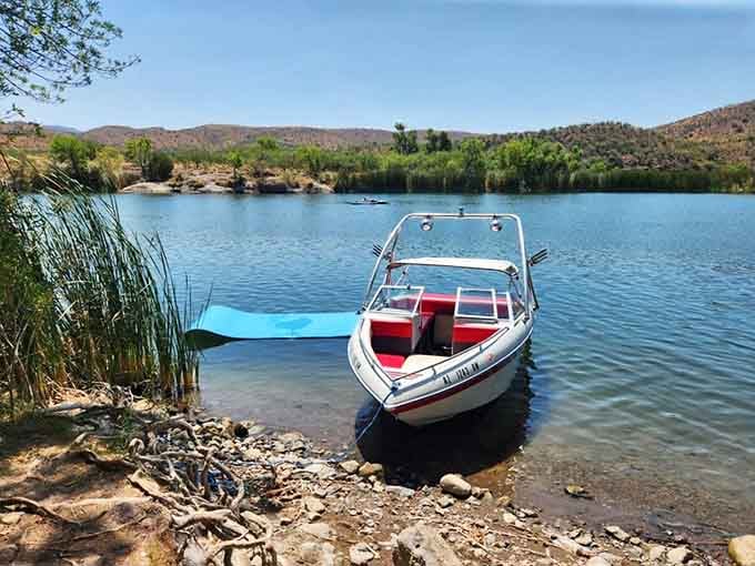 That classic boat waiting at the shore is your ticket to pretending you're in a lake vacation commercial.