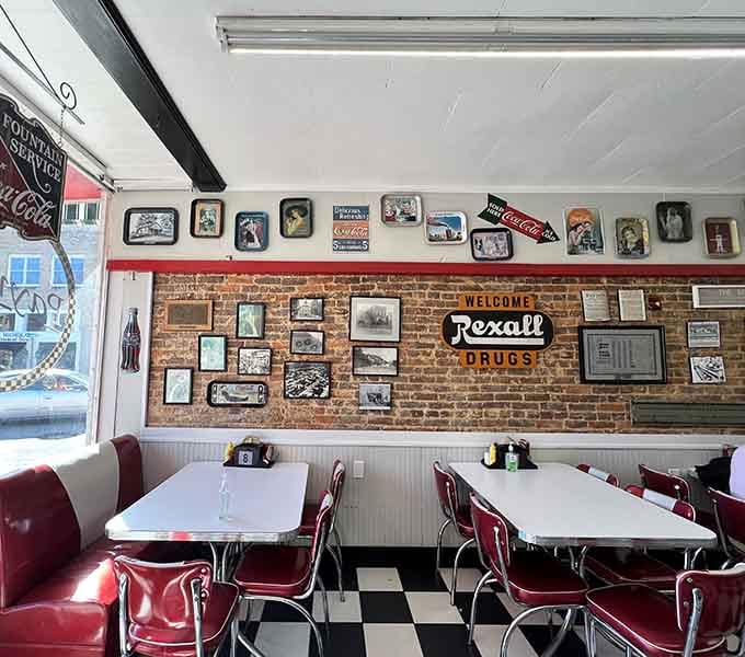 Exposed brick, vintage signs, and white tables create an atmosphere money can't buy but time generously provides.