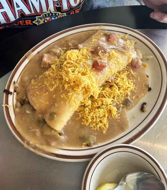 Breakfast burrito smothered in green chili and cheese, a Colorado tradition done absolutely right.
