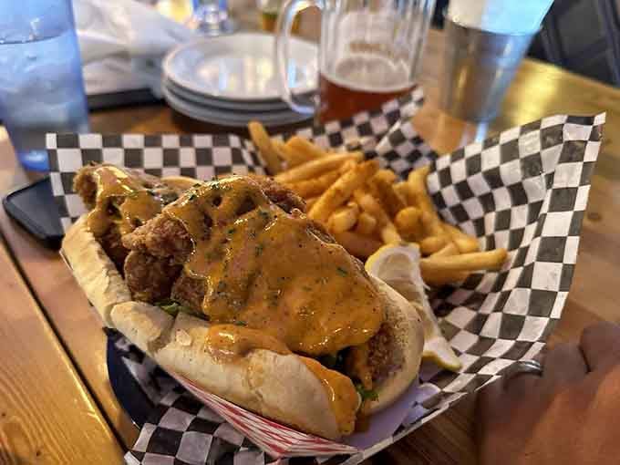 That overstuffed po' boy with golden fried fish spilling out is basically a Louisiana hug on a bun.