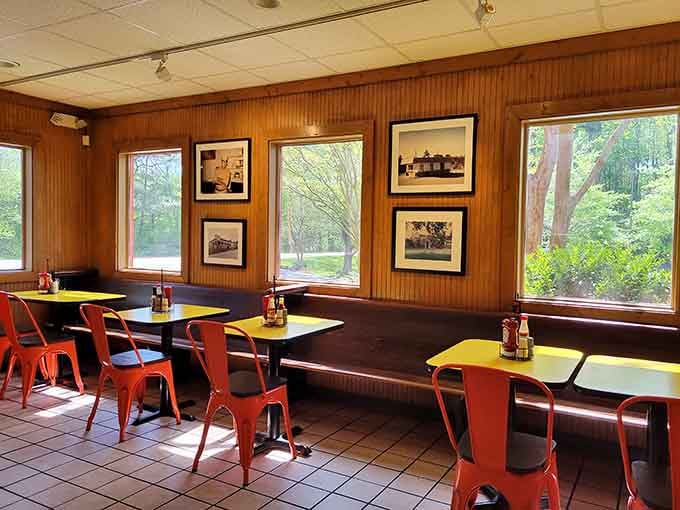 Window-side seating with natural light and vintage photographs creates a comfortable space to enjoy your meal at a leisurely pace.