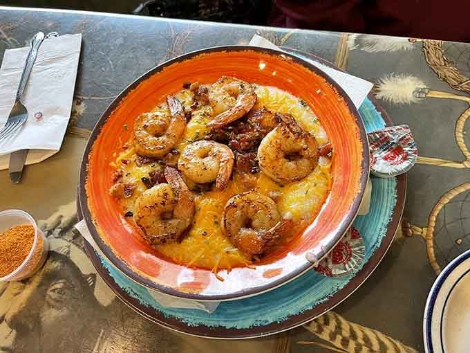 Shrimp and grits getting fancy with cheddar, bringing a touch of Southern coastal cuisine to your breakfast plate.