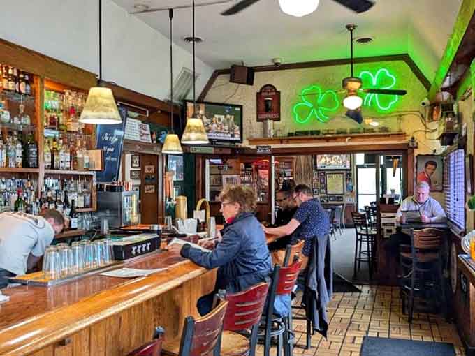 The bar area glows with green shamrock neon, proving this pub celebrates more than just Gothic literature.