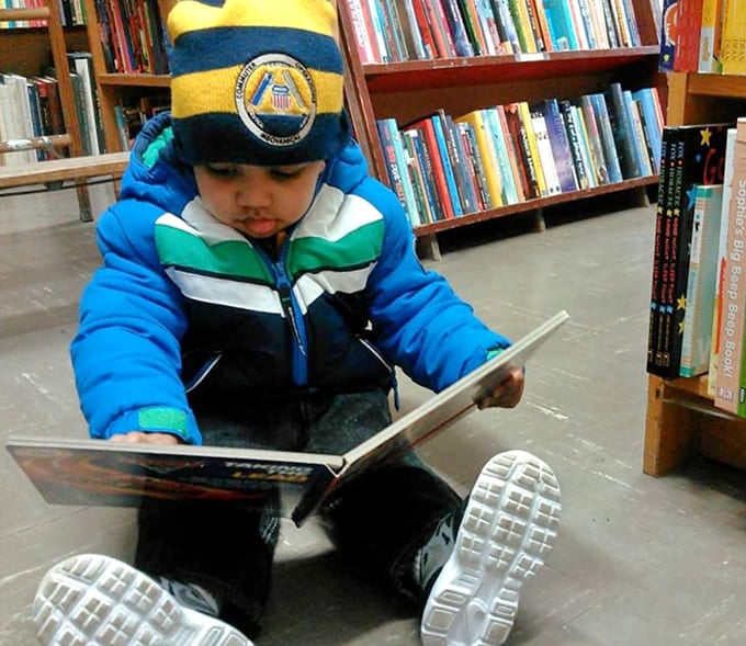 Future bookworm in training, already mastering the art of getting completely lost in a good story.