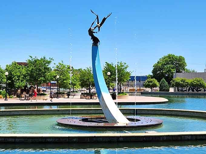 This graceful fountain sculpture rises from the water like art decided to take a swim.