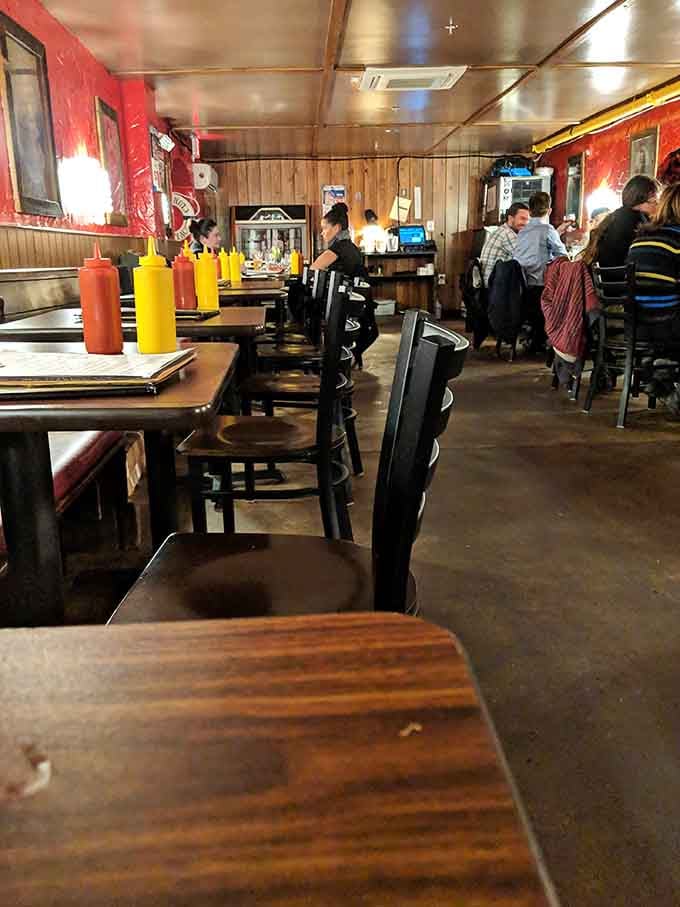 Wood paneling and cozy booths create the kind of atmosphere where conversations flow as freely as the drinks.