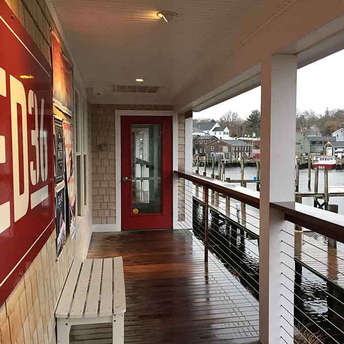 That red door entrance overlooking the water is your portal to waterfront dining bliss and culinary happiness.