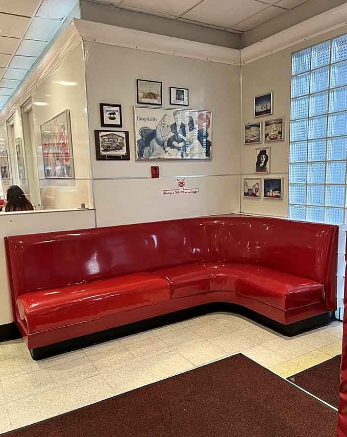Corner booth seating with classic diner photos, the perfect spot to settle in for serious eating business.