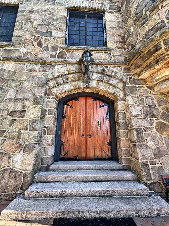 This wooden door has welcomed guests for generations, heavy iron hinges and all.