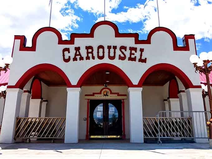 The Spirit of Columbia Gardens Carousel brings whimsical joy with its red-trimmed facade. Inside, painted ponies gallop in endless circles of affordable family entertainment.