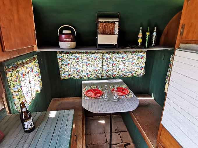 The travel trailer's cozy interior features seating arrangements that make modern RVs look like they're trying way too hard.