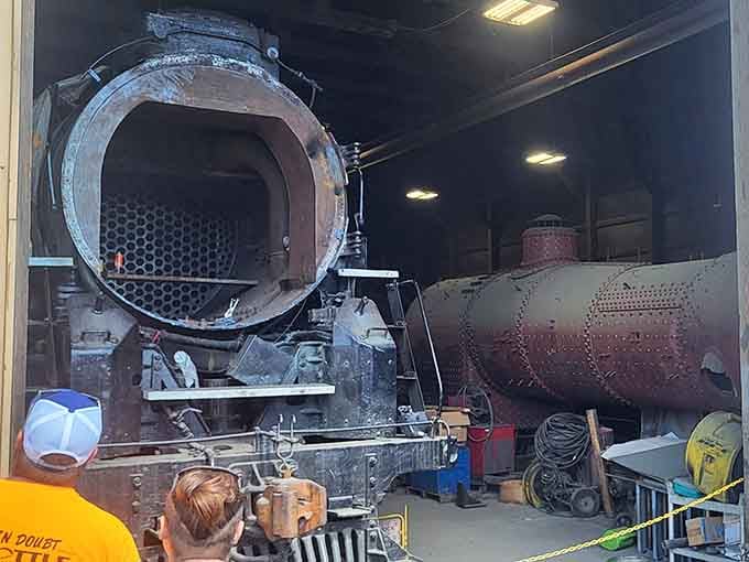 The restoration shop where skilled craftspeople perform mechanical surgery on locomotives, keeping history alive through dedicated hands-on work.