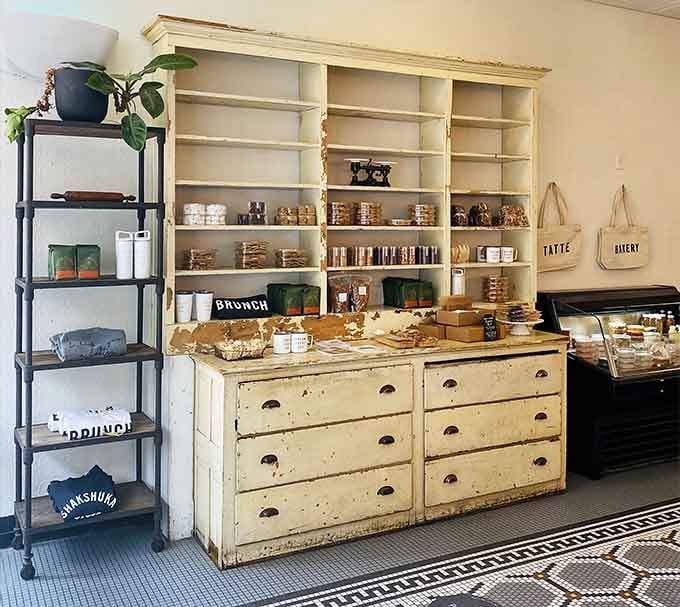 Vintage drawers turned pastry display showcase golden baked goods like edible treasures waiting to be discovered and devoured.