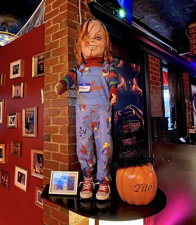 Chucky stands ready to greet guests, his overalls and sneakers making him oddly approachable for a killer doll.