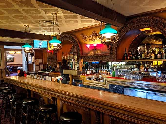 The bar area glows with vintage charm and colorful lights, where drinks taste better surrounded by this much history.