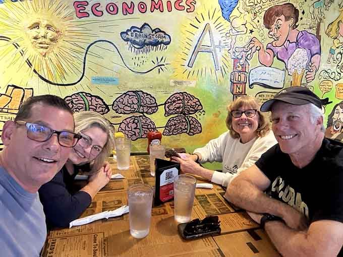 Happy diners surrounded by decades of graffiti and artwork, proving good food tastes better in interesting company and surroundings.