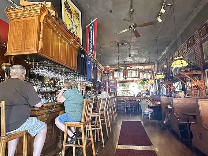 The bar stretches invitingly beneath pressed tin ceilings where locals and visitors alike gather to solve the world's problems, one pint at a time.