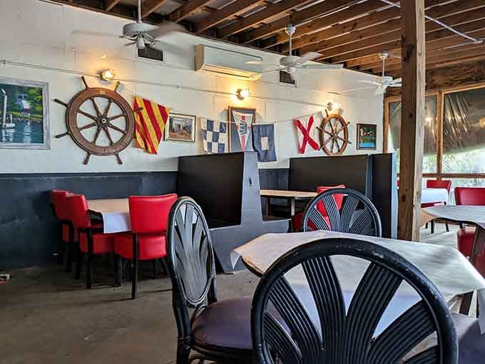 Red chairs and maritime decor create a dining room that's casual enough for flip-flops, special enough for memories.